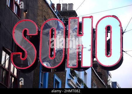 A 'Soho' sign or signage above Beak Street, Soho, London, UK, welcome ...