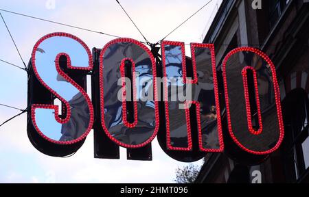 A 'Soho' sign or signage above Beak Street, Soho, London, UK, welcomes ...