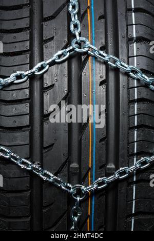 snow chains on a vehicle tire, snow chain obligation in winter snow ...
