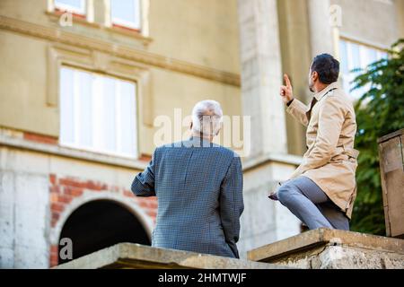 Two amazing senior businessmen are looking and discussing Stock Photo ...