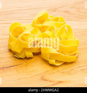 italian tagliatelle pasta nests on a white background - natural food ...