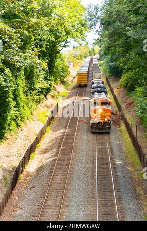 orange BNSF American freight trains from bridge above railway tracks ...