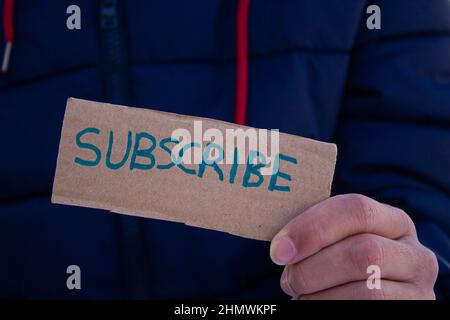 Man holding cardboard box with subscribe word Stock Photo - Alamy
