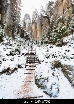 Tourists visit the snow-covered rocks at Baiyun Mountain Scenic Area in ...