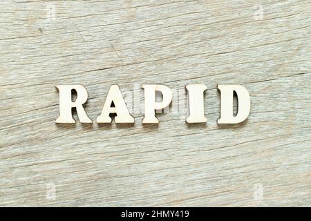 Wood letter in word rapid on green grass background Stock Photo - Alamy