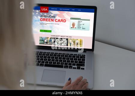 Green card in a search engine on the computer. laptop near the flag of ...