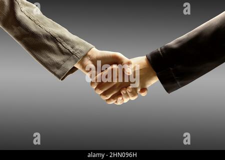 Business handshake on gray background Stock Photo - Alamy