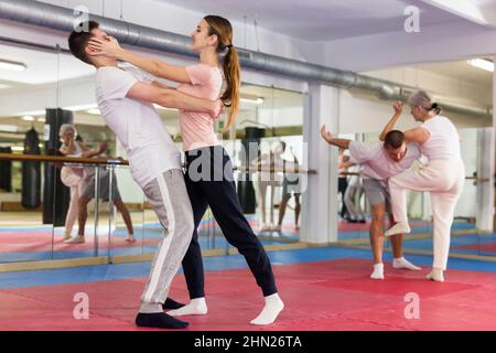 Woman performing eye-gouging move during self-defence training Stock ...