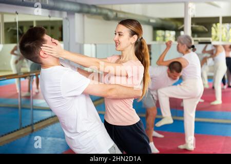 Woman performing eye-gouging move during self-defence training Stock ...
