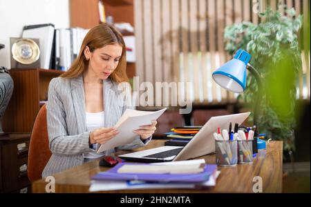 Female secretary doing paperwork in office Stock Photo - Alamy