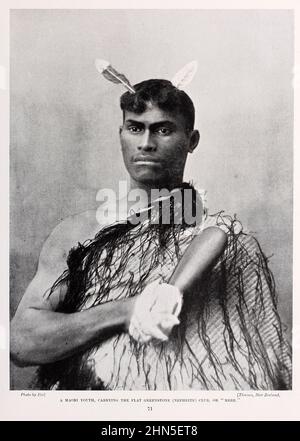 A Maori youth carrying the flat greenstone (nephrite) club known as a ...