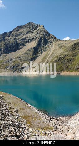 Reservoir between the mountains in the austrian alps Stock Photo - Alamy