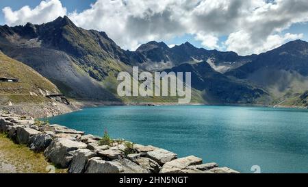 Reservoir between the mountains in the austrian alps Stock Photo - Alamy