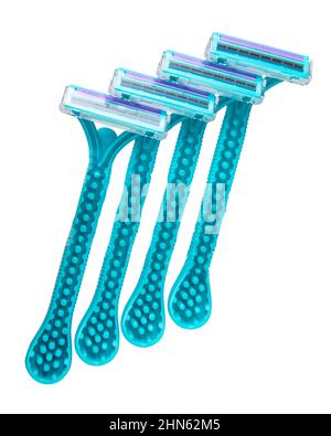 top view of green disposable razors and depilation wax stripes on green ...