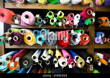 different fabric bolts exposed on shelves Stock Photo - Alamy