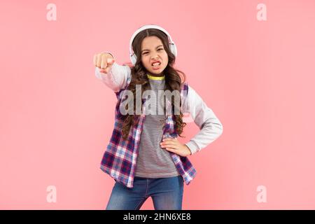 modern life in childhood. angry child listen music in headphones. kid ...