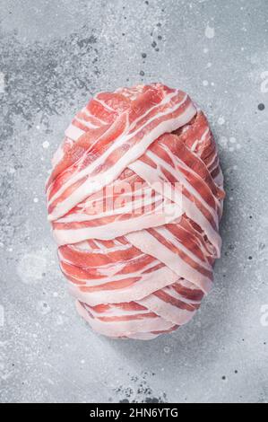 Raw meatloaf in bacon on dark stone table Stock Photo - Alamy