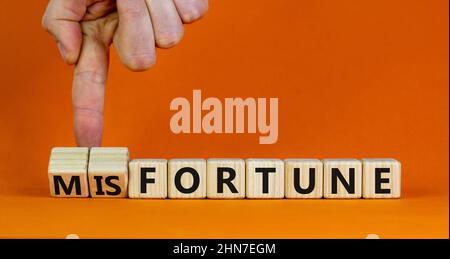 Fortune or misfortune symbol. Businessman turns wooden cubes and ...