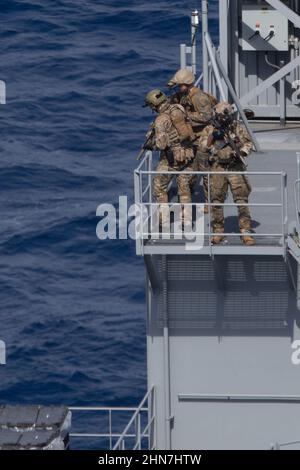 Expeditionary staging base USS Miguel Keith(ESB-5) (right) is flanked ...