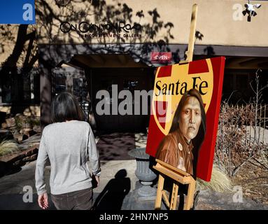A woman enters an art gallery featuring paintings my Native-American ...