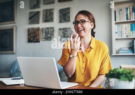 Keeping in touch. Cropped shot of an unrecognizable businesswoman using ...