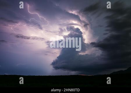 A flash of lightning illuminates the landscape near a wind farm in ...