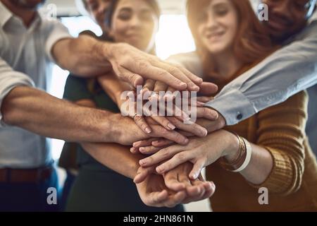 Success belongs to those who grab it. Shot of a group of colleagues ...