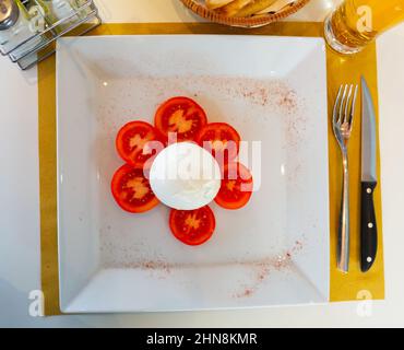 Italian snack Buratta with tomatoes Stock Photo - Alamy