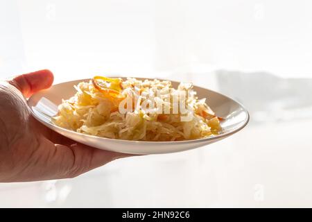 Sauerkraut with vegetable oil in rays of daylight. National european ...