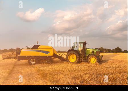 Process of hay making during harvesting Stock Photo - Alamy