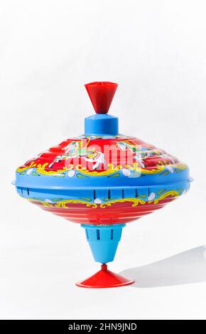 A child's metal spinning top (humming top) with a horse design in red ...