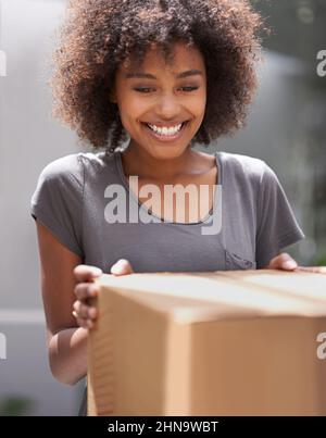 Service with a smile. Shot of a courier making a delivery to a smiling ...