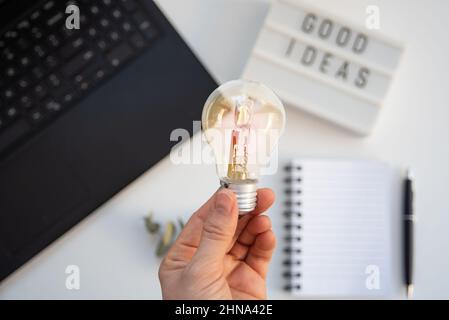 Working desk with a lightbulb, inspiration and new ideas Stock Photo ...