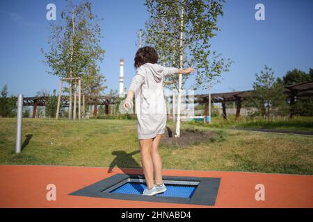 Adult woman jumps on a trampoline jumping balloon in Iceland on a ...