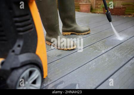 Man jet washing a patio Stock Photo - Alamy