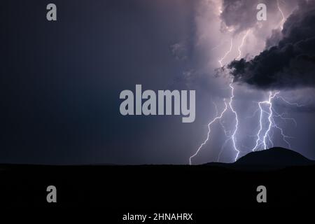 A flash of lightning illuminates the landscape near a wind farm in ...
