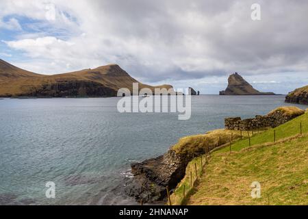 View of the coast near Bour on the island of Vagar. Massive cliffs ...