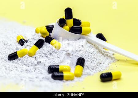 measuring spoon with casein or caffeine powder, food supplement ...