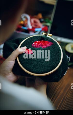 Yarn and thread for embroidering on cloth by hand on a wooden surface ...