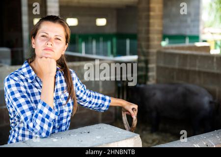 Portrait of female farmer feeding iberian pigs on farm Stock Photo - Alamy