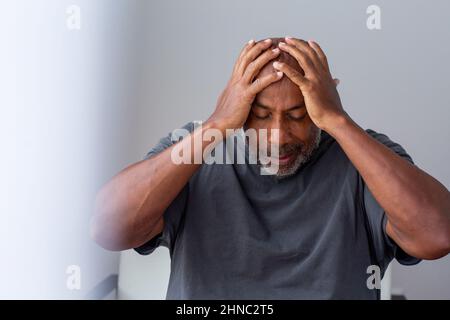 Older man not feeling well and having a headache Stock Photo - Alamy