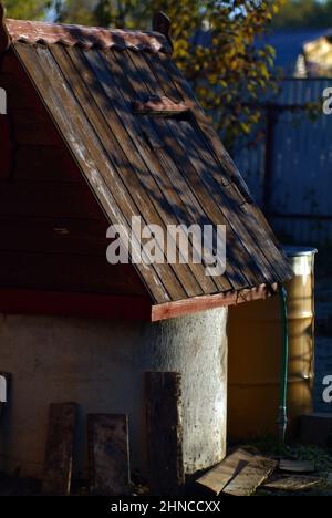 Stone well with a wooden roof and a bucket of water in beautifully ...