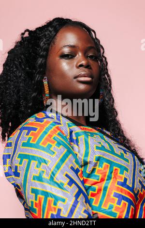 Studio portrait millennial woman with bright red Color hair and yellow ...