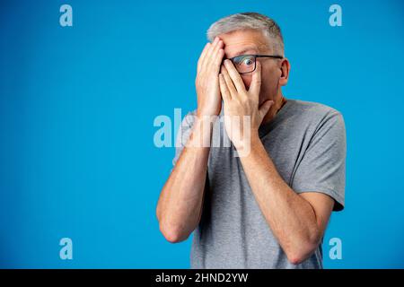 Scared middle age man nervous expressing anxiety and panic gesture ...