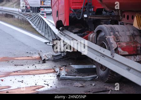 Damaged guard rail or guardrail between the pavement and road following ...