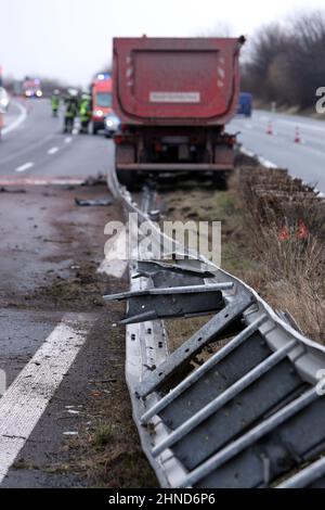 Damaged guard rail or guardrail between the pavement and road following ...