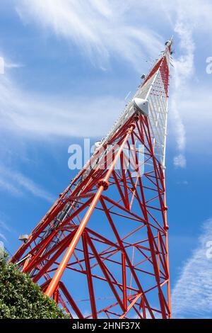 red and white broadcast towers or pylons of radio and tv stations in ...