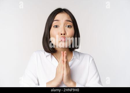 Cute asian woman begging, say please, asking for favour, need help ...