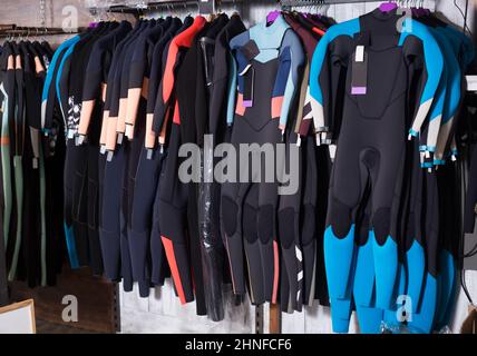 Image of colorful wetsuit hanging in the store for surfing Stock Photo ...
