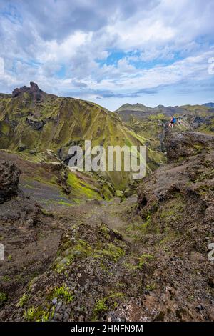Hiker looks over spectacular landscape, moss-covered cliffs, Pakgil ...